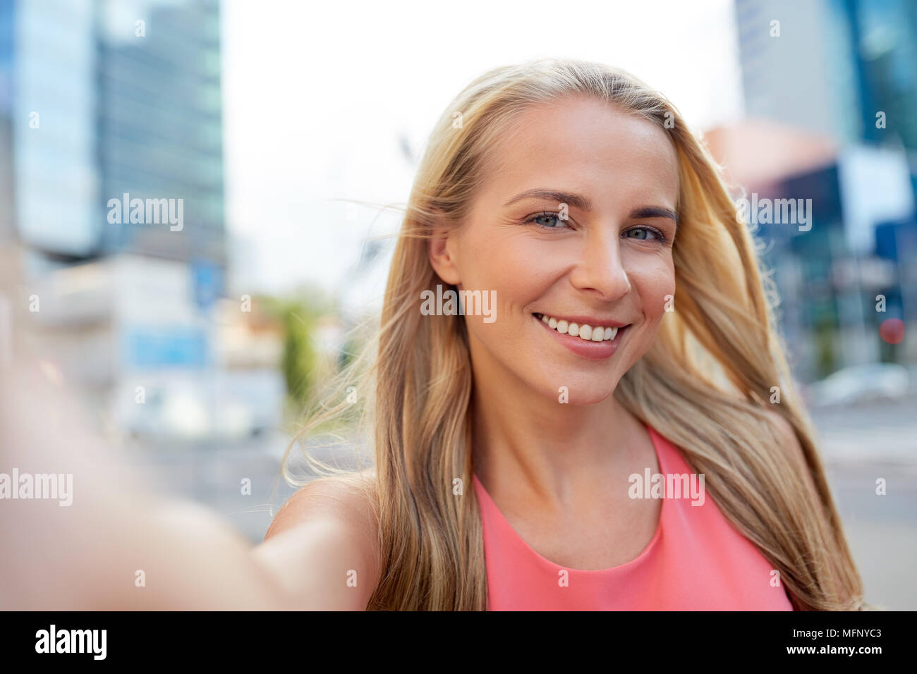 happy young woman taking selfie on city street Stock Photo - Alamy
