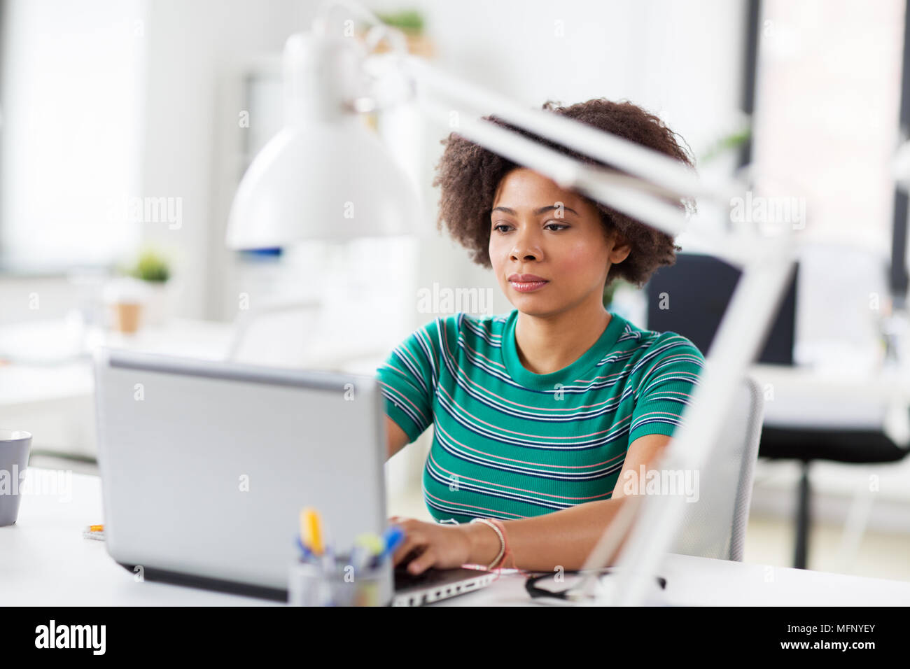 african woman with laptop computer at office Stock Photo - Alamy