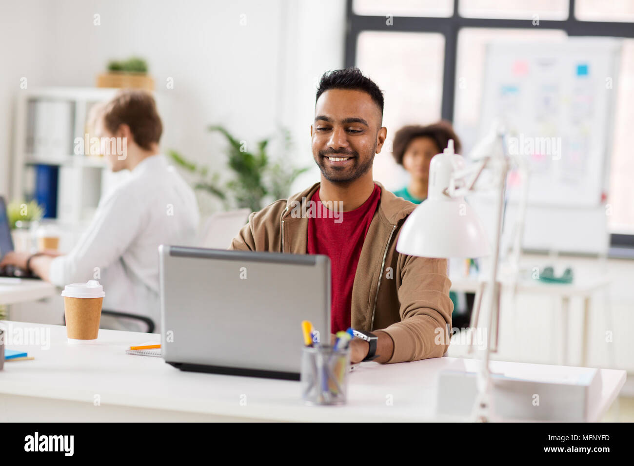 happy indian man with laptop computer at office Stock Photo - Alamy