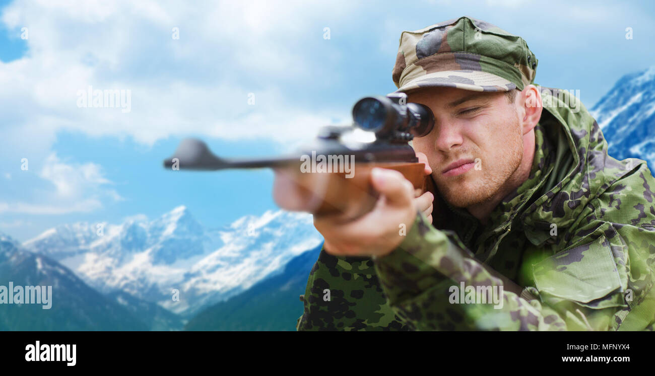 soldier or hunter with gun aiming or shooting Stock Photo - Alamy