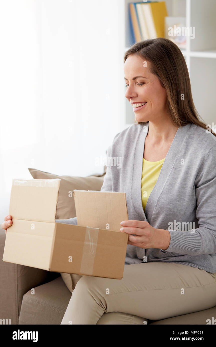 Woman opening parcel at home hi-res stock photography and images - Alamy