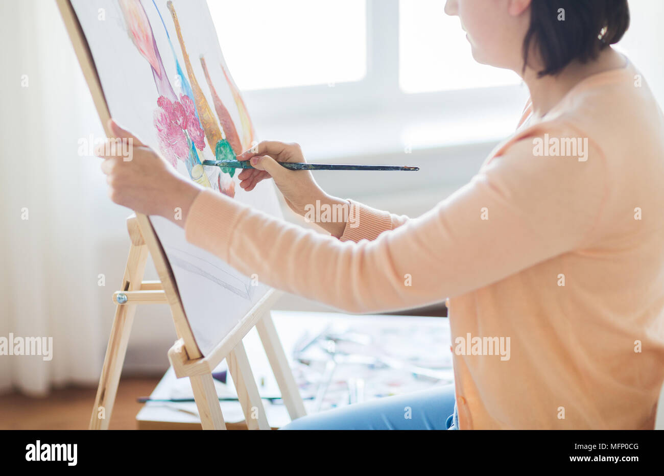 artist with brush painting still life at studio Stock Photo - Alamy
