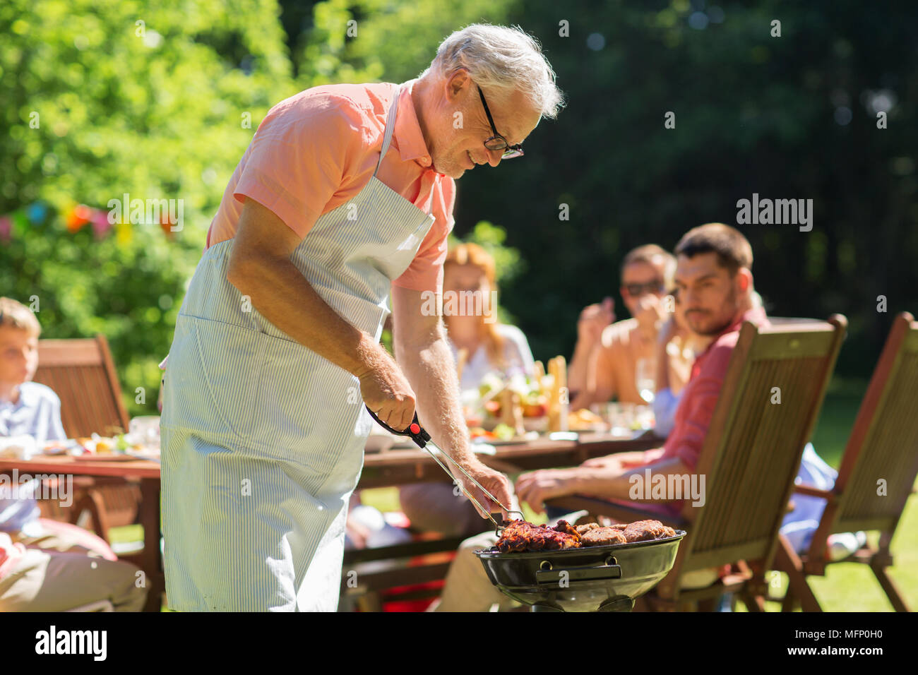 senior man cooking meat on barbecue grill outdoors Stock Photo - Alamy