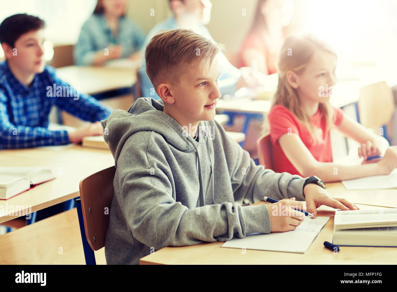 group of students with notebooks at school lesson Stock Photo - Alamy