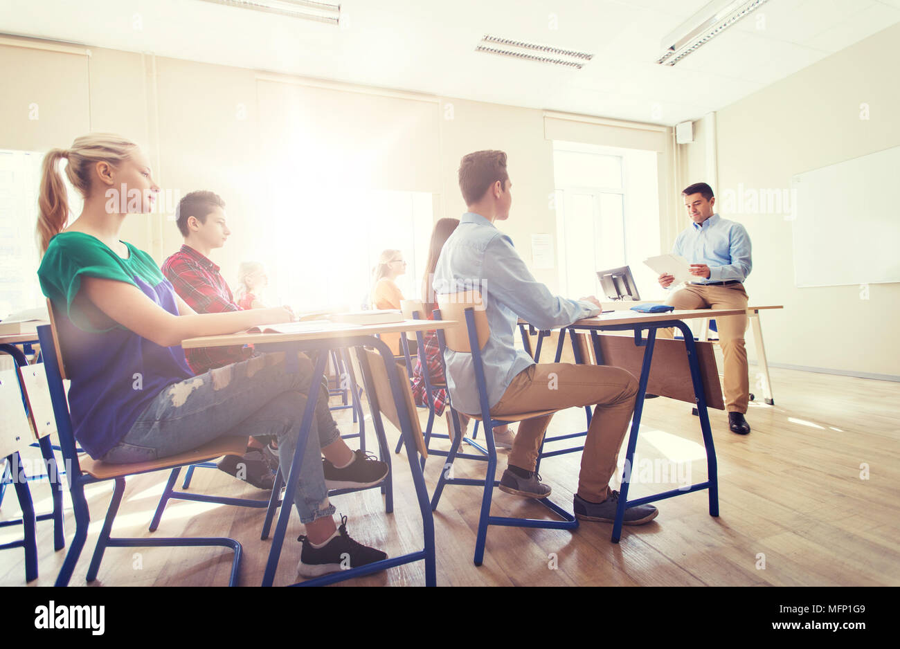 group of students and teacher with papers or tests Stock Photo - Alamy