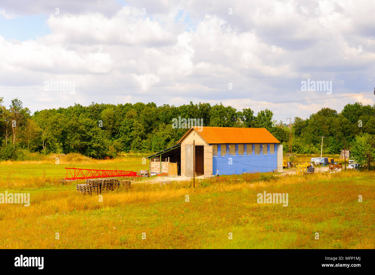 Blue farm on the green grass Stock Photo - Alamy