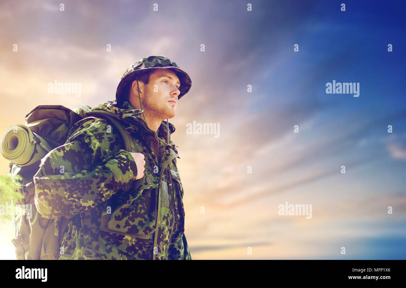 soldier in military uniform with backpack hiking Stock Photo - Alamy