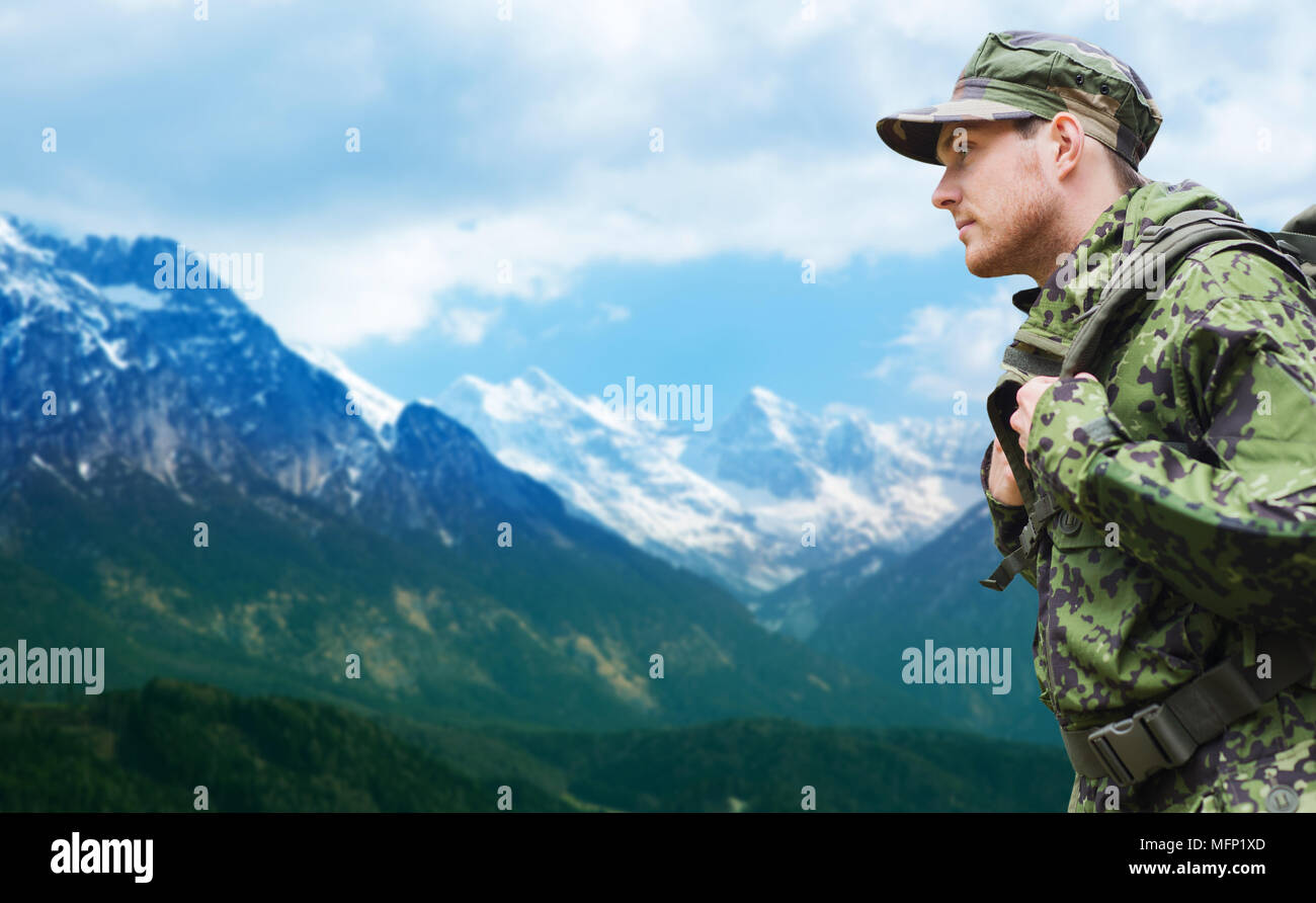 soldier in military uniform with backpack hiking Stock Photo - Alamy
