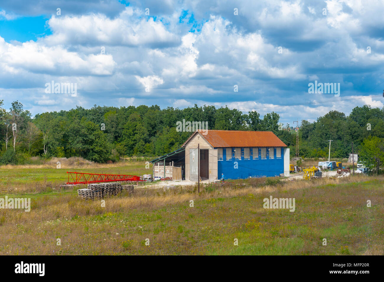 Blue farm on the green grass Stock Photo - Alamy