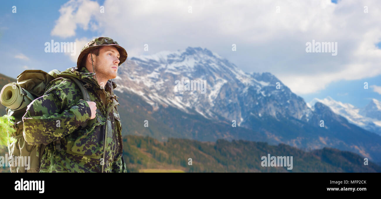 soldier in military uniform with backpack hiking Stock Photo - Alamy