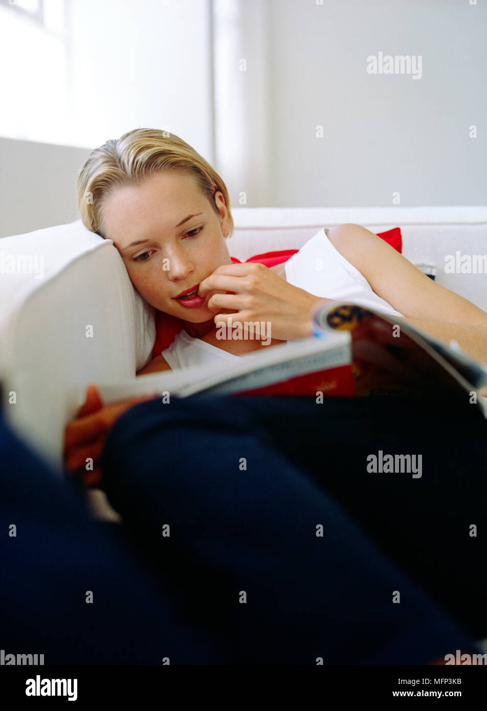 Woman relaxing in recliner reading hi-res stock photography and images ...
