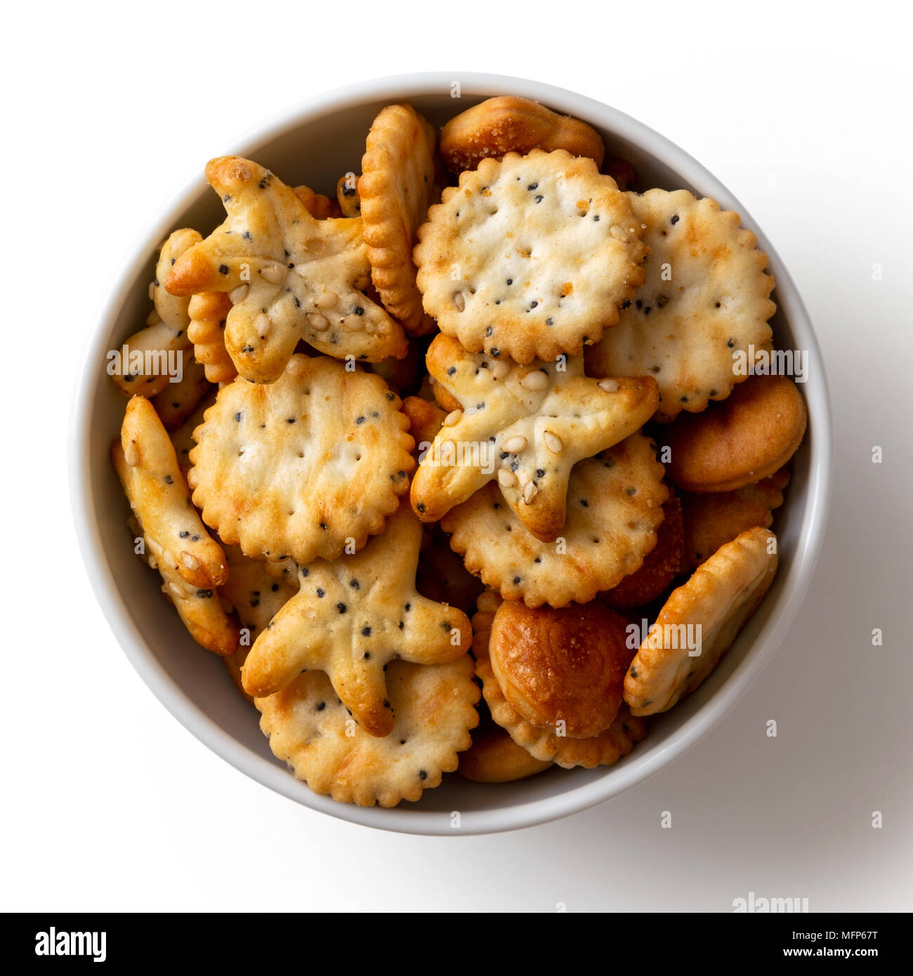 Baked party poppy seed crackers in white ceramic dish isolated on white ...