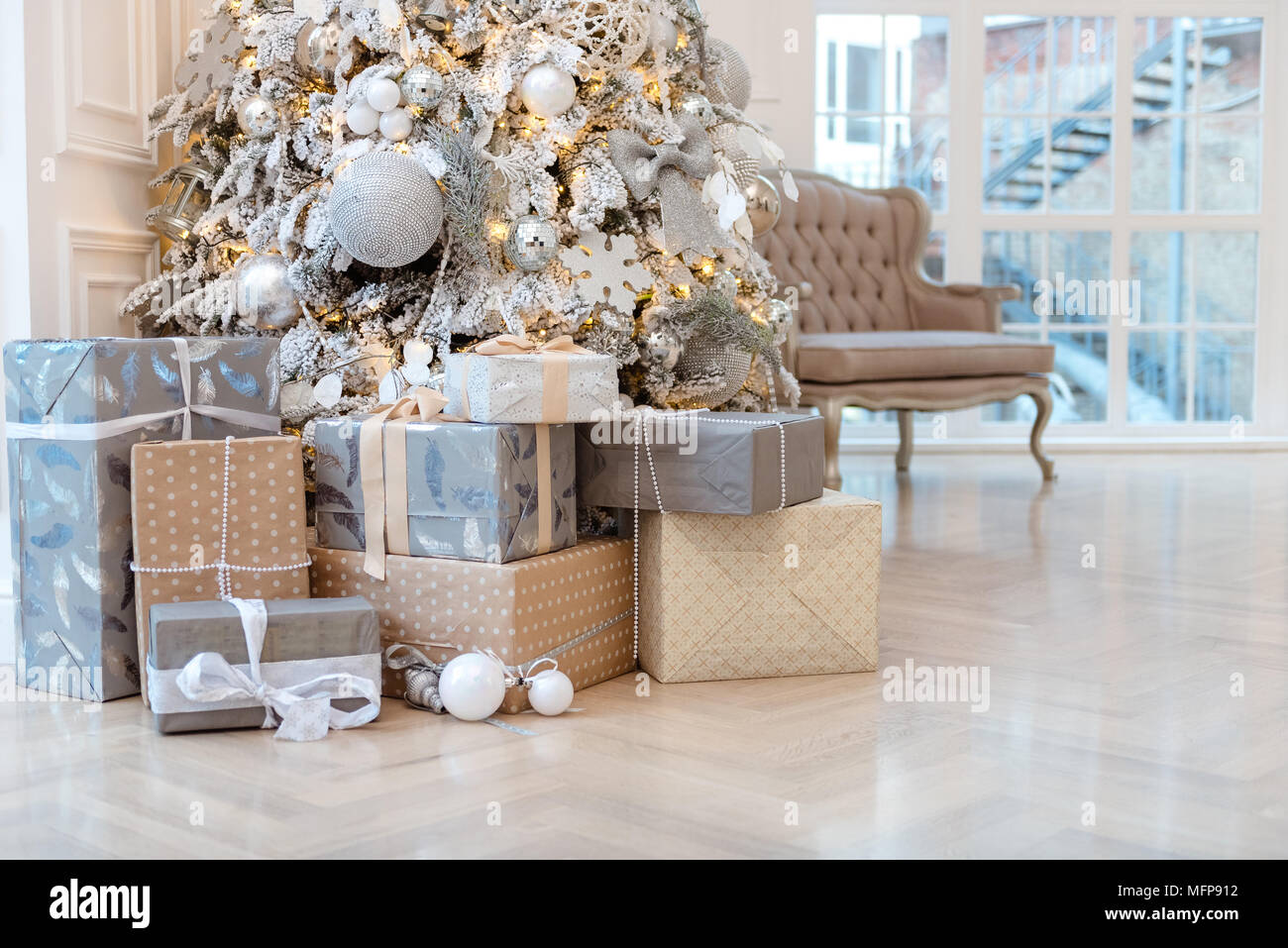 Gifts under the Christmas tree lights background Stock Photo - Alamy