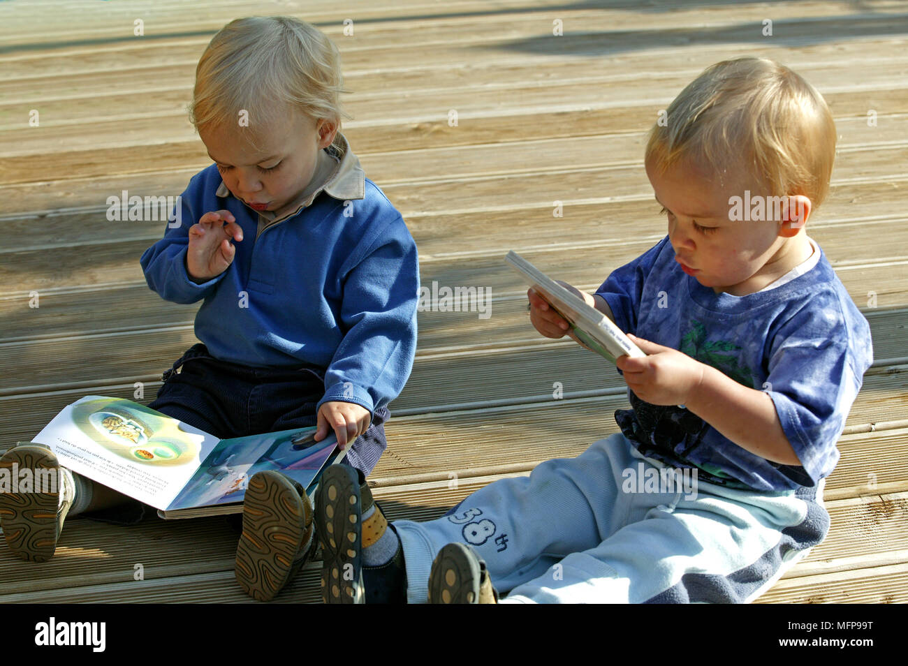 Boys reading a Book Stock Photo - Alamy