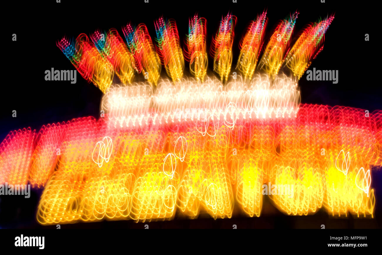 An energetic abstract of the lights of a high-energy fairground sign at ...