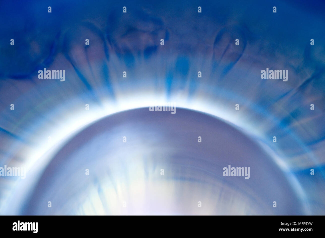Close-up abstract of a glass object using natural reflected light to ...