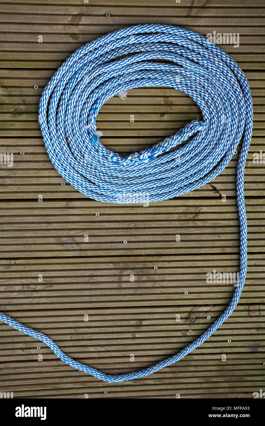 Number 9 coiled rope on decking Stock Photo - Alamy