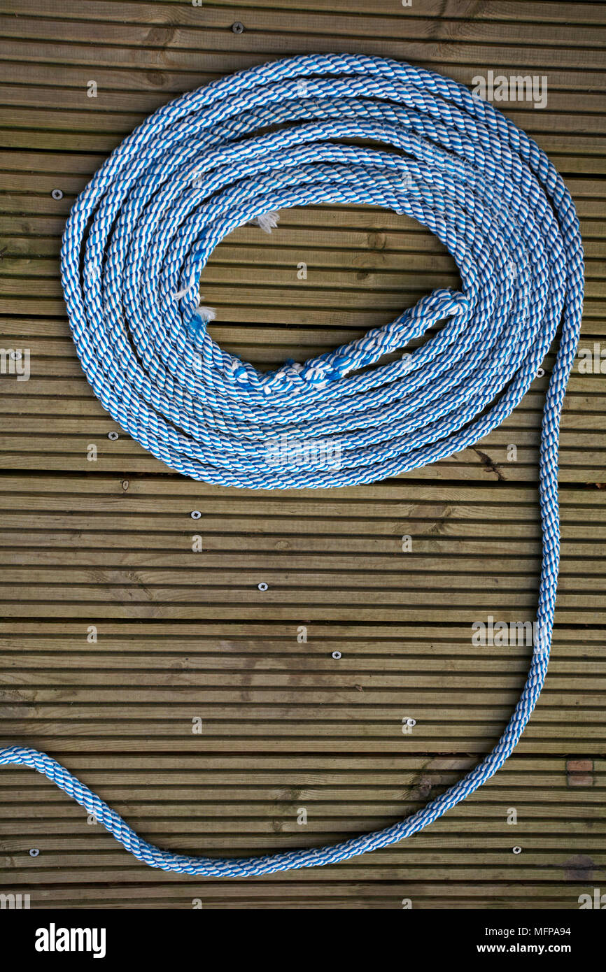 Number 9 coiled rope on decking Stock Photo - Alamy