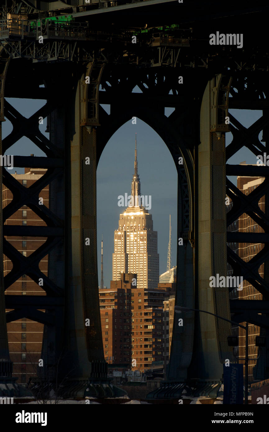 Empire State Building seen through Manhattan Bridge, New York, USA ...