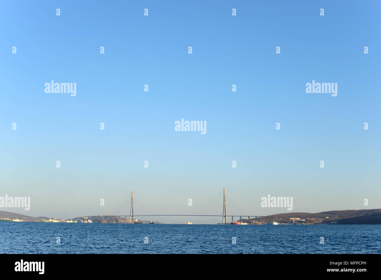 Distant suspension bridge over the sea background. Free copy space ...