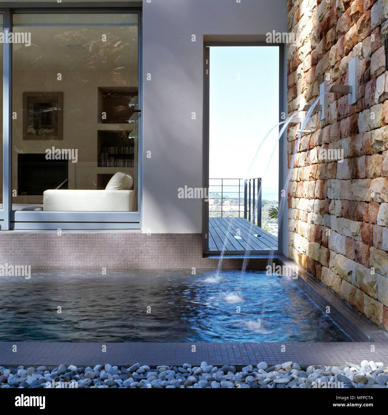 Lap pool beside decking terrace with view to inside house Stock Photo ...