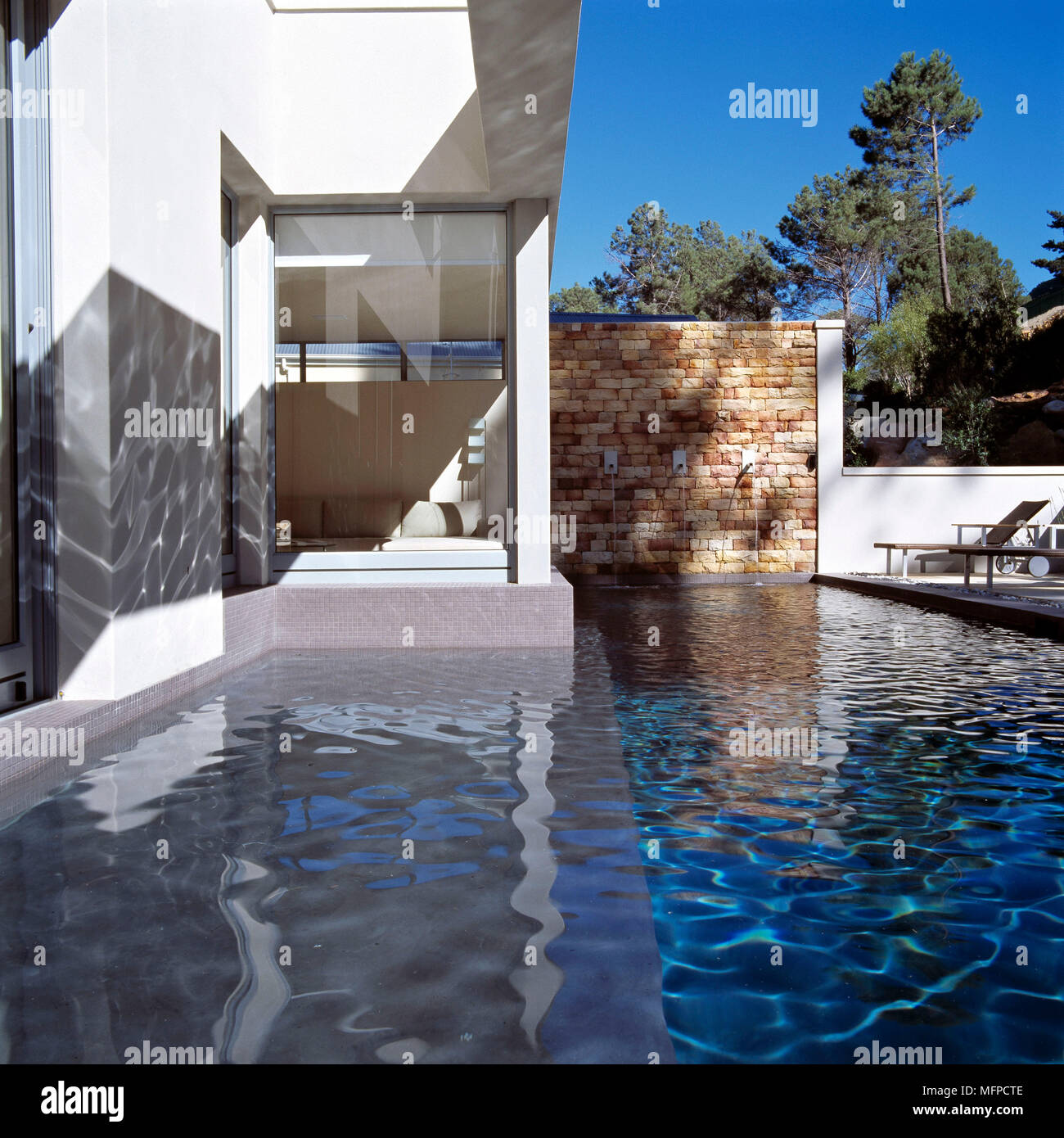 Swimming pool with view into house Stock Photo - Alamy