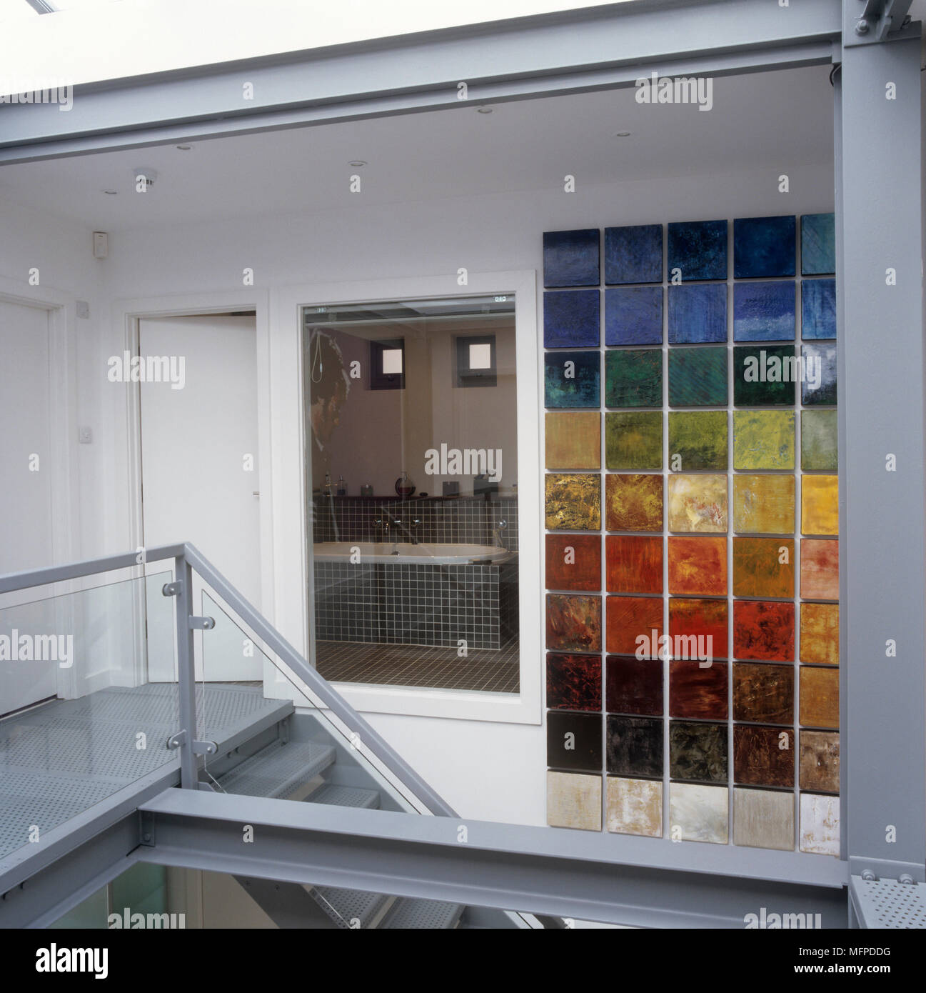 Steel walkway under glass skylight with bathroom seen through window ...