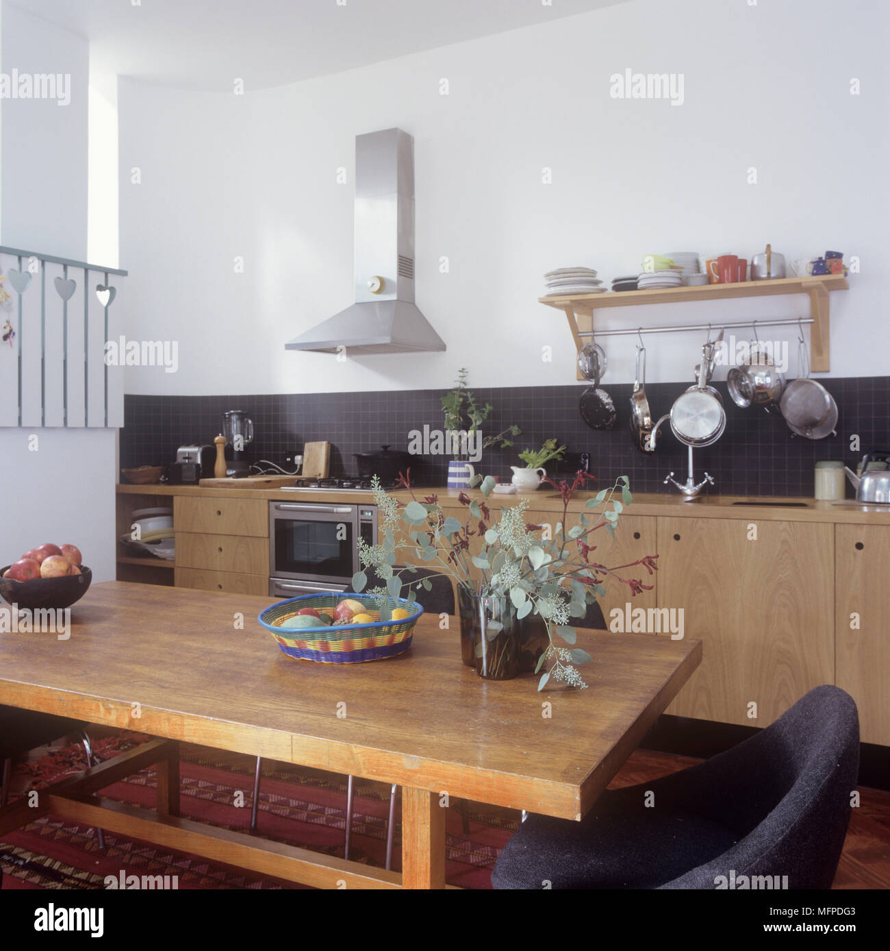 Kitchen with wood units, table and chairs Stock Photo - Alamy