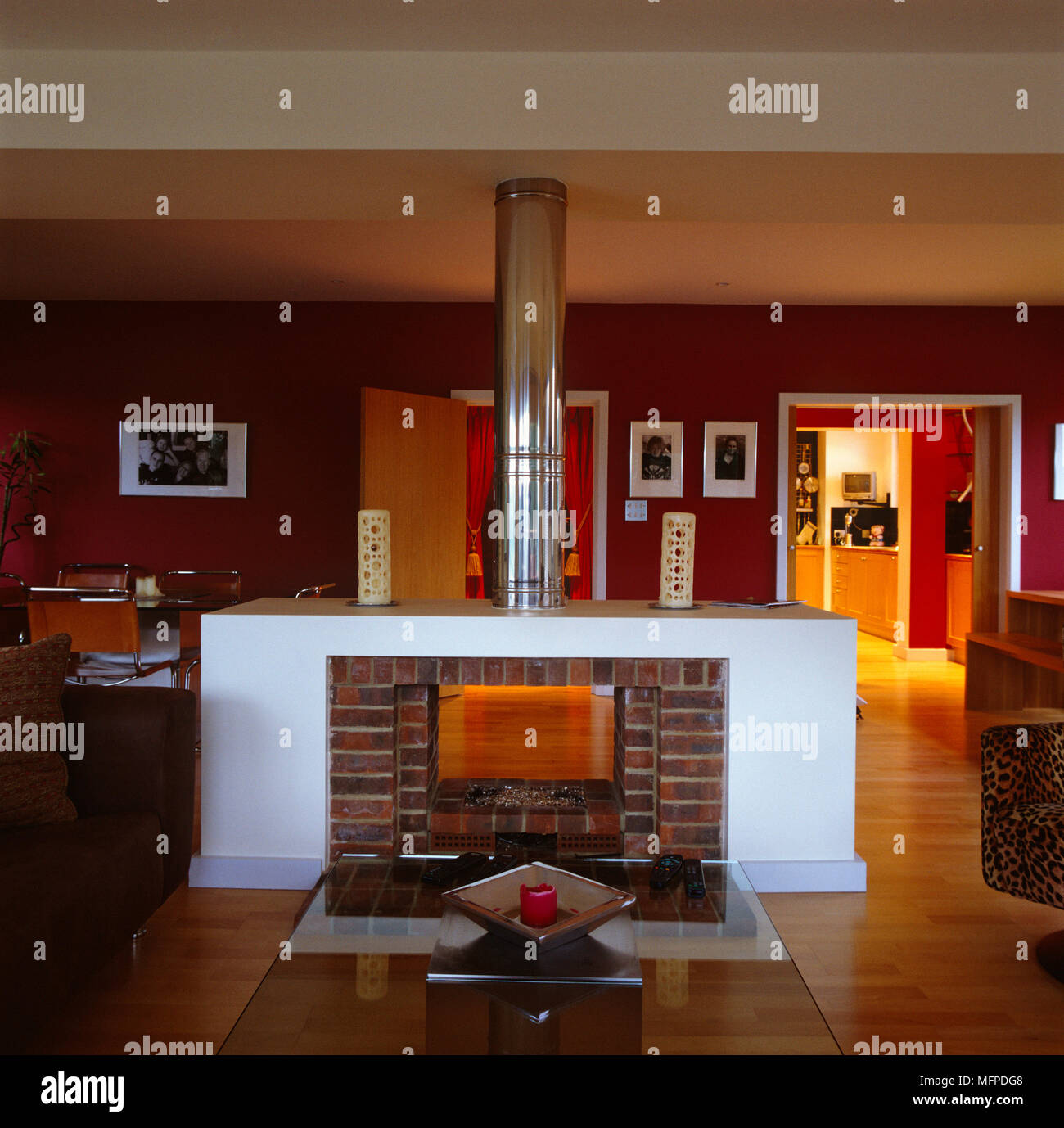 Brick fireplace with chimney in centre of room Stock Photo - Alamy
