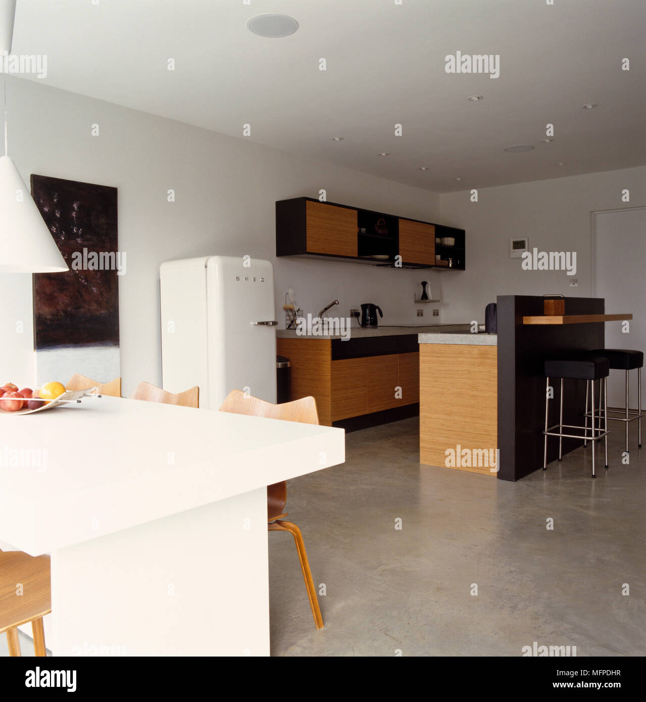Kitchen area with a breakfast bar and wood units Stock Photo - Alamy