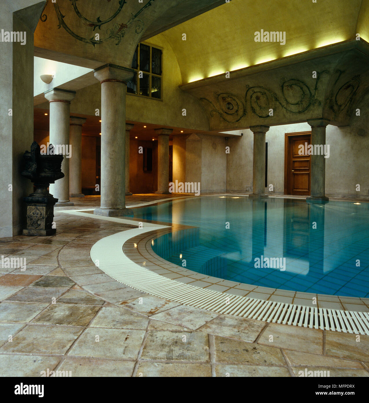 Opulent indoor swimming pool with stone floor and columns Stock Photo ...