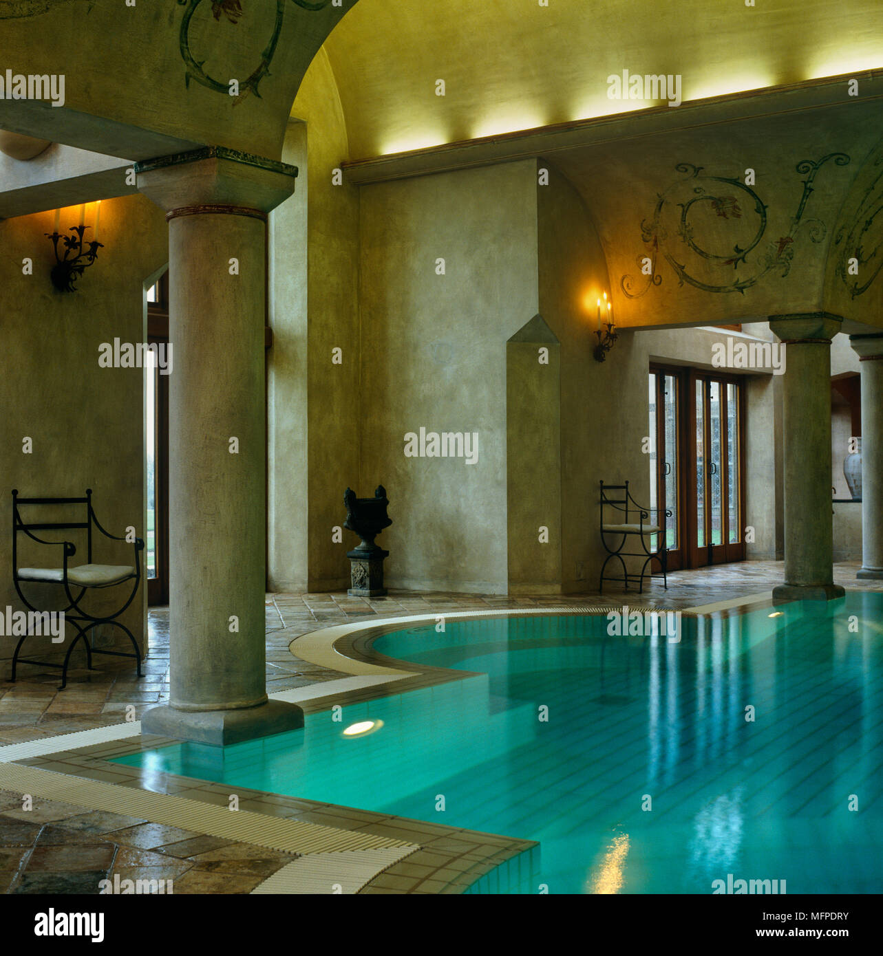 Opulent indoor swimming pool with stone floor and columns Stock Photo ...