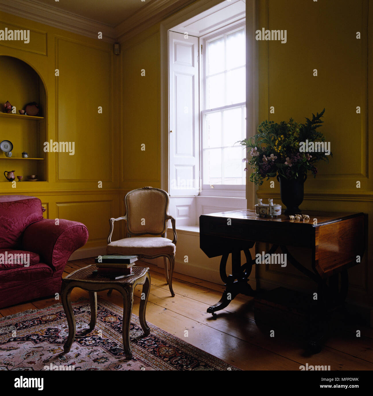 Period style lyre table next to window in yellow sitting room Stock ...