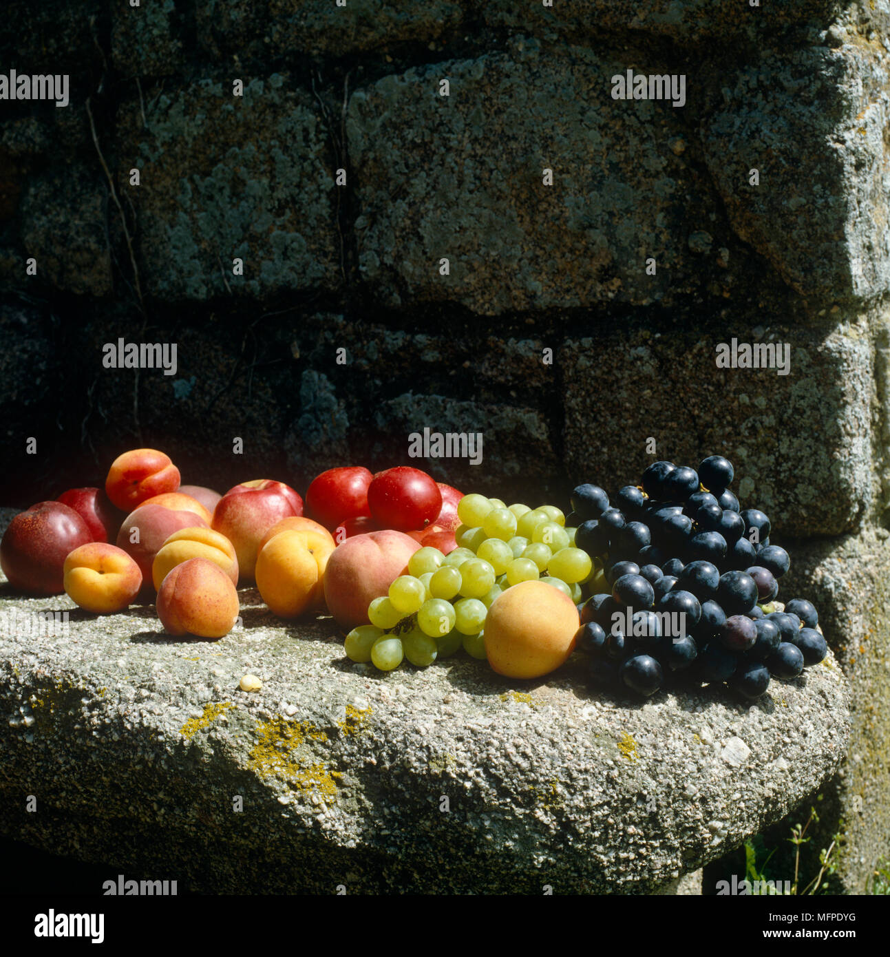 Close up of fruit on stone ledge by wall Stock Photo - Alamy