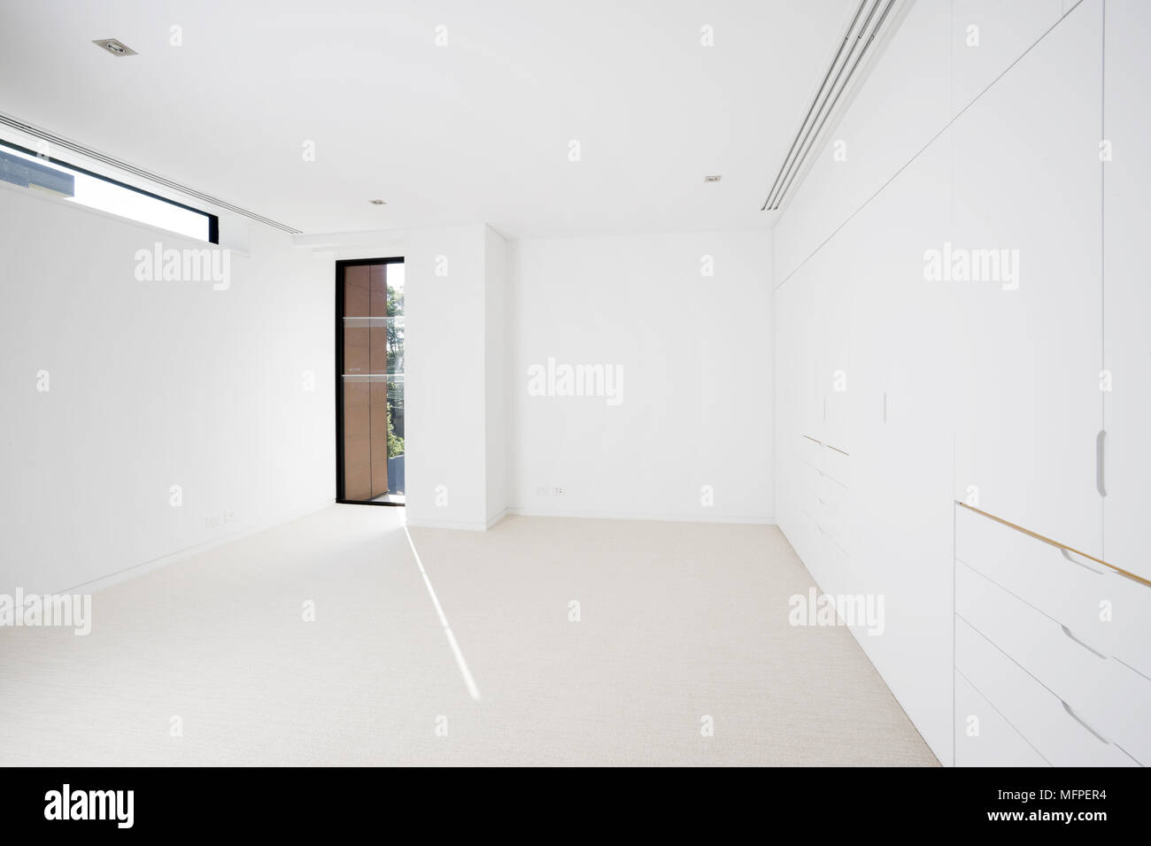 Built in storage units in empty white room Stock Photo - Alamy