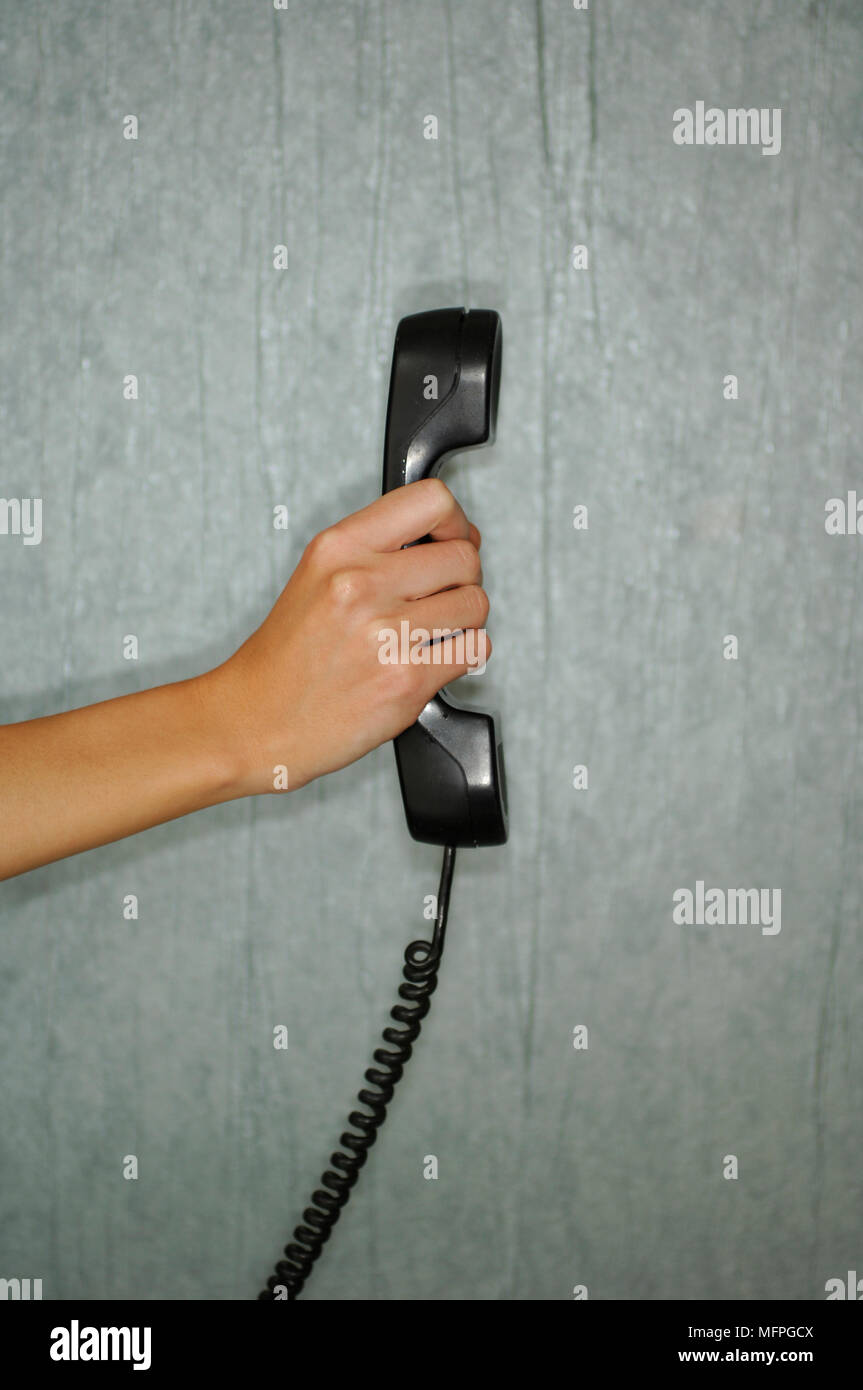 Womans hand holding phone receiver hi-res stock photography and images ...