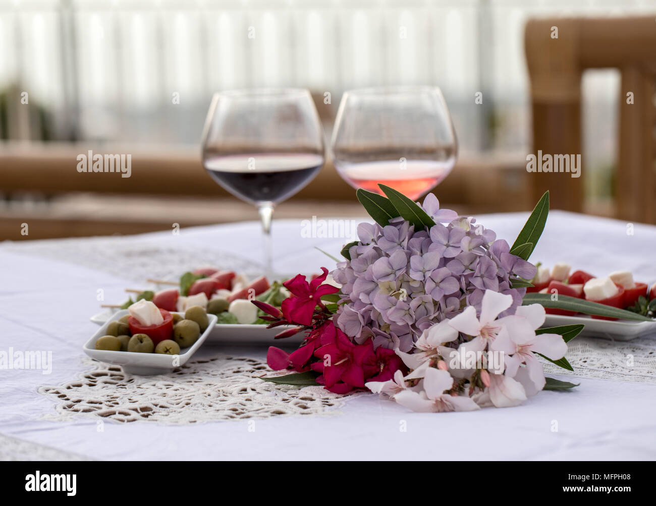 Table on the terrace prepared for a romantic dinner Stock Photo - Alamy