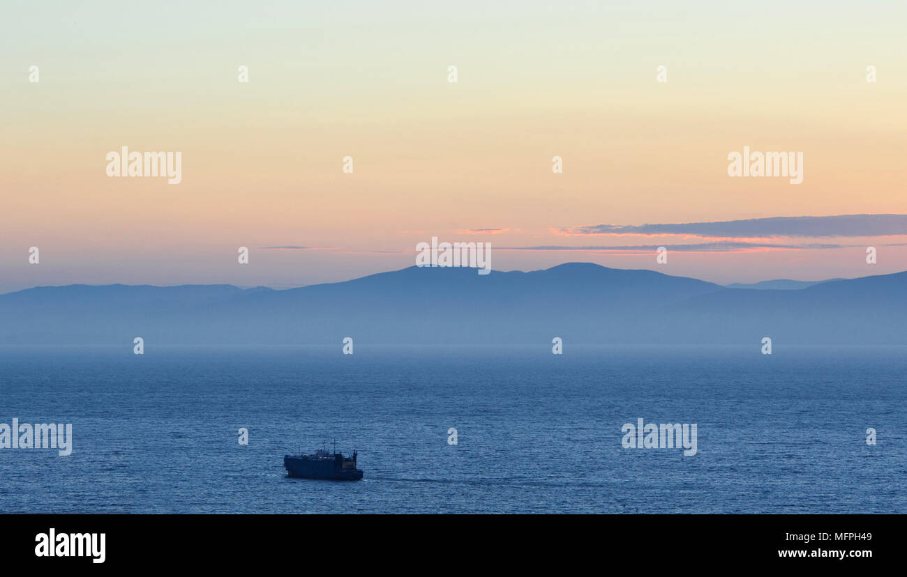 Little ship silhouette in sunset sea background Stock Photo - Alamy