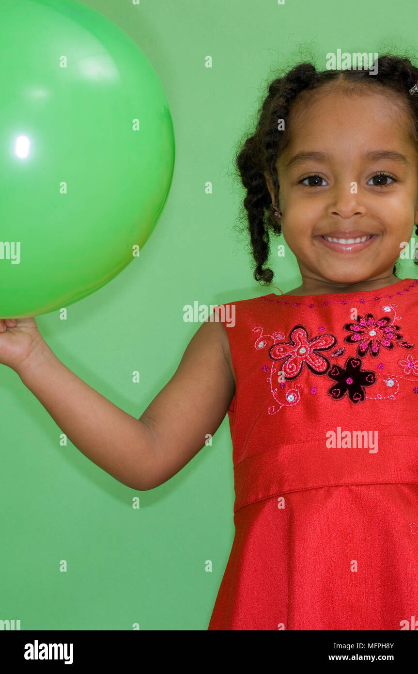 Portrait of a girl holding a balloon and smiling Ref: CRUSC 10032 065 ...
