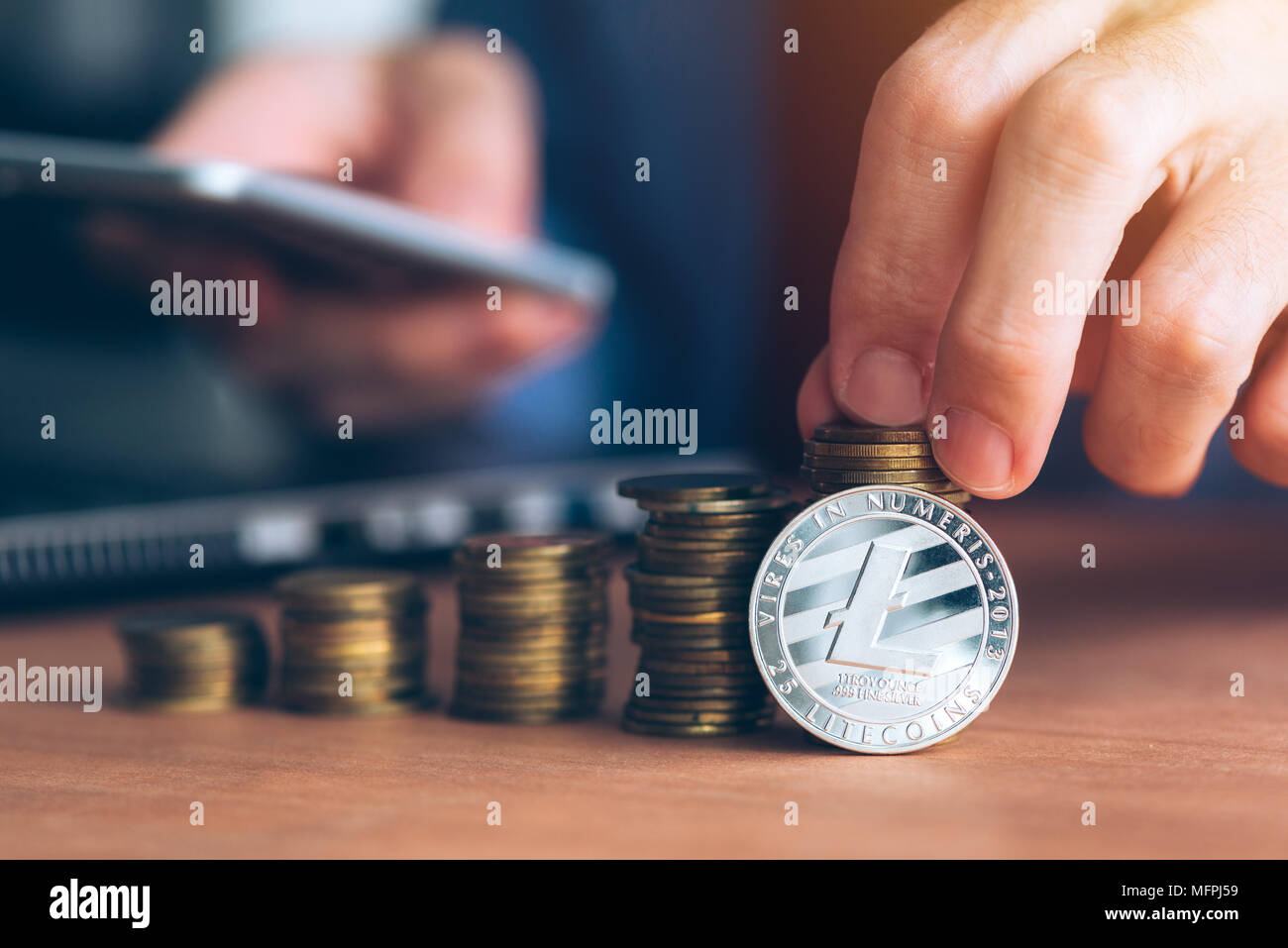 Litecoin cryptocurrency trader, business person using modern technology electronic to trade with ...