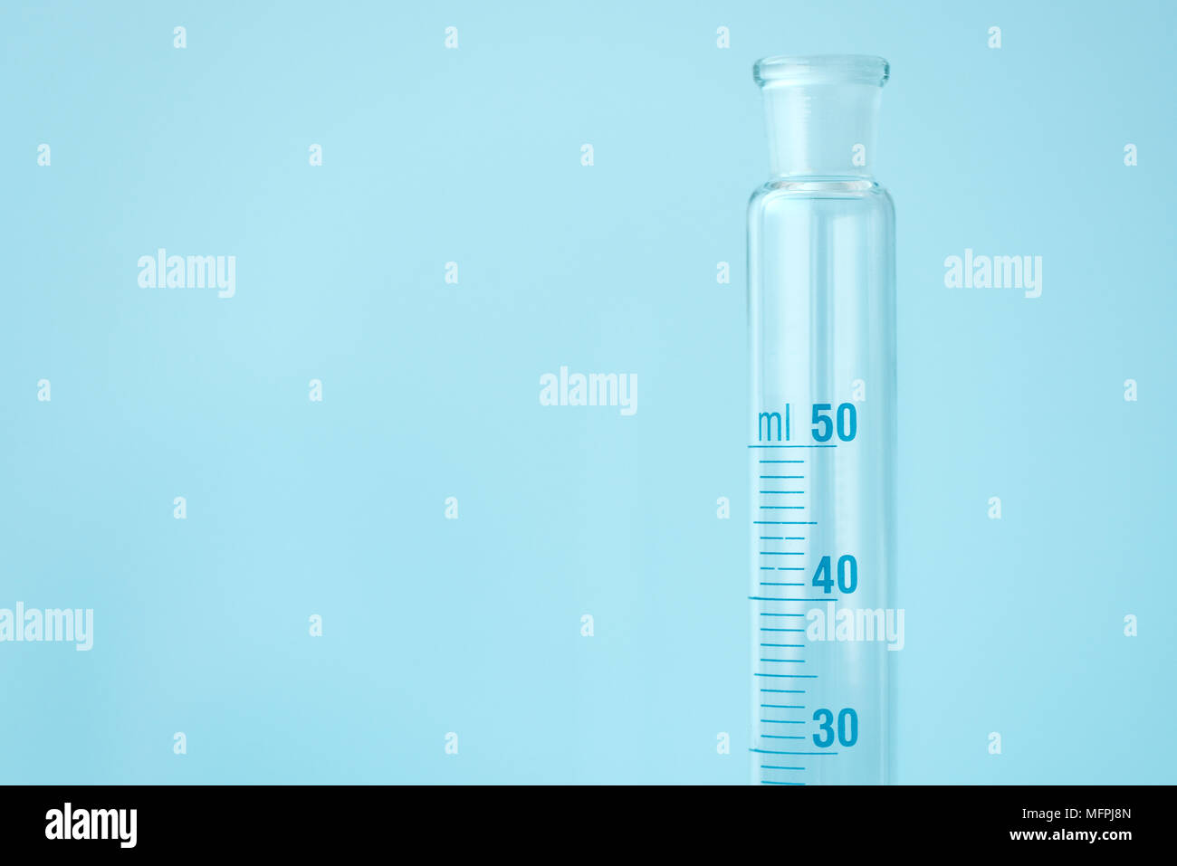 Mixing cylinder volumetric laboratory glassware with blank copy space ...