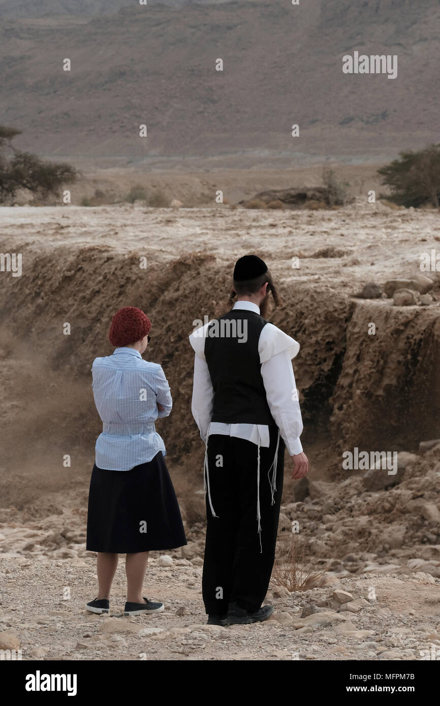 Ultra orthodox Jewish couple gazing at a flooded motorway along the ...