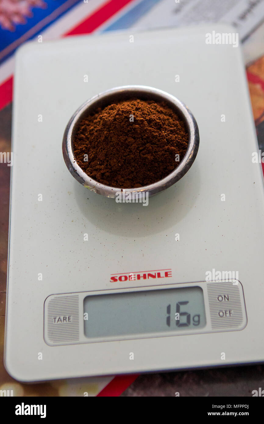 Ground Coffee Beans being weighed by scale inside portafilter ready to ...