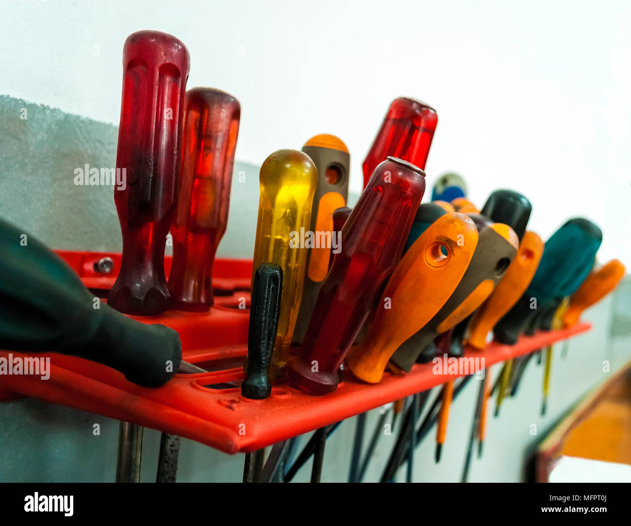 Tools seating in wall mounted tool holder in private mechanical ...