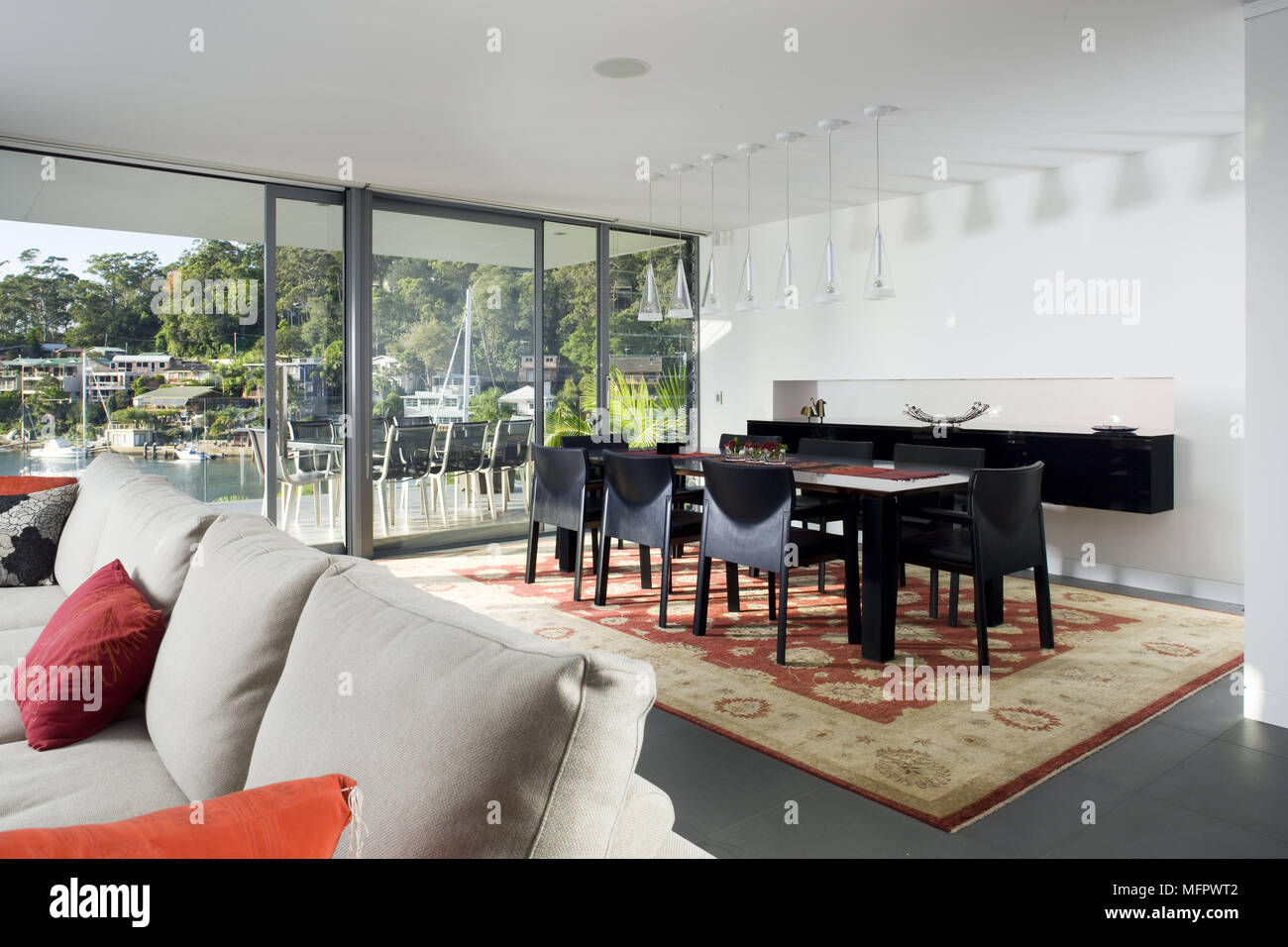 Dining table and chairs in modern open plan room Stock Photo - Alamy