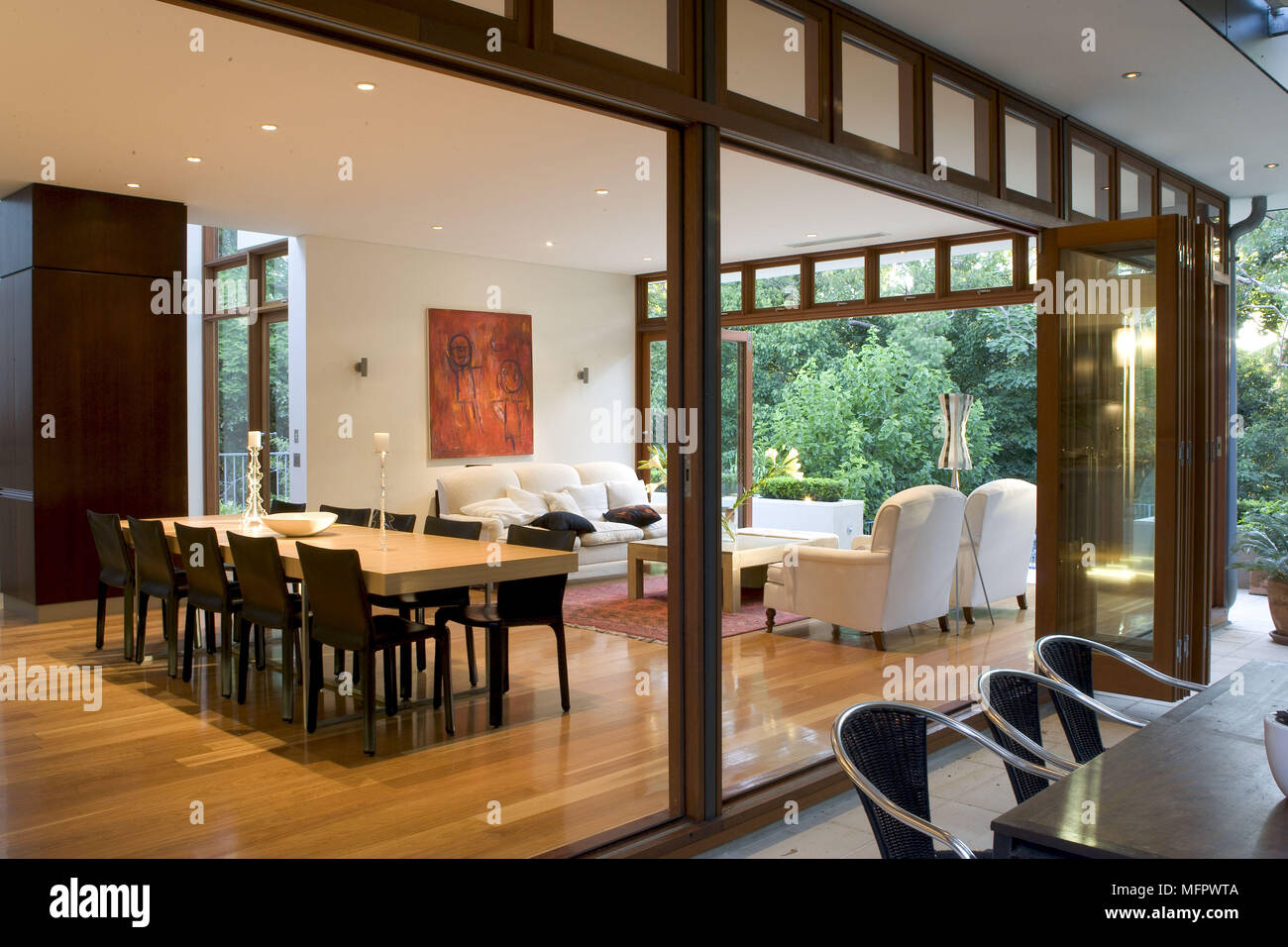 Dining table and chairs in modern open plan room with sitting area ...