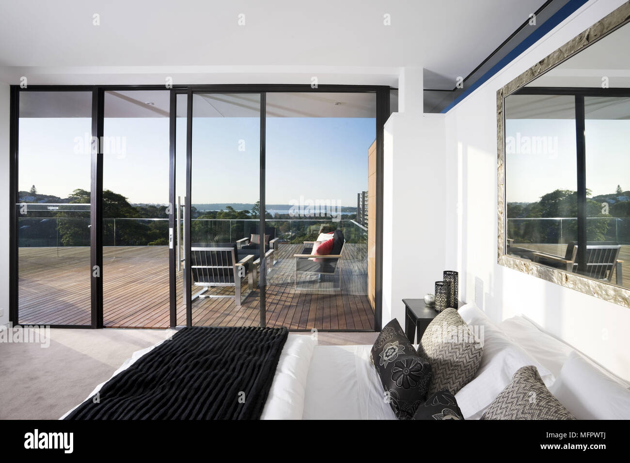 Double bed in modern bedroom with view though patio door Stock Photo ...
