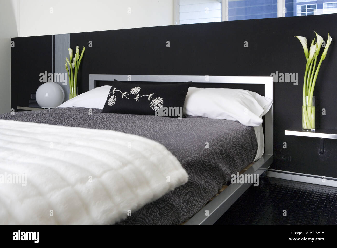 Double bed with partition wall as headboard in modern bedroom Stock ...
