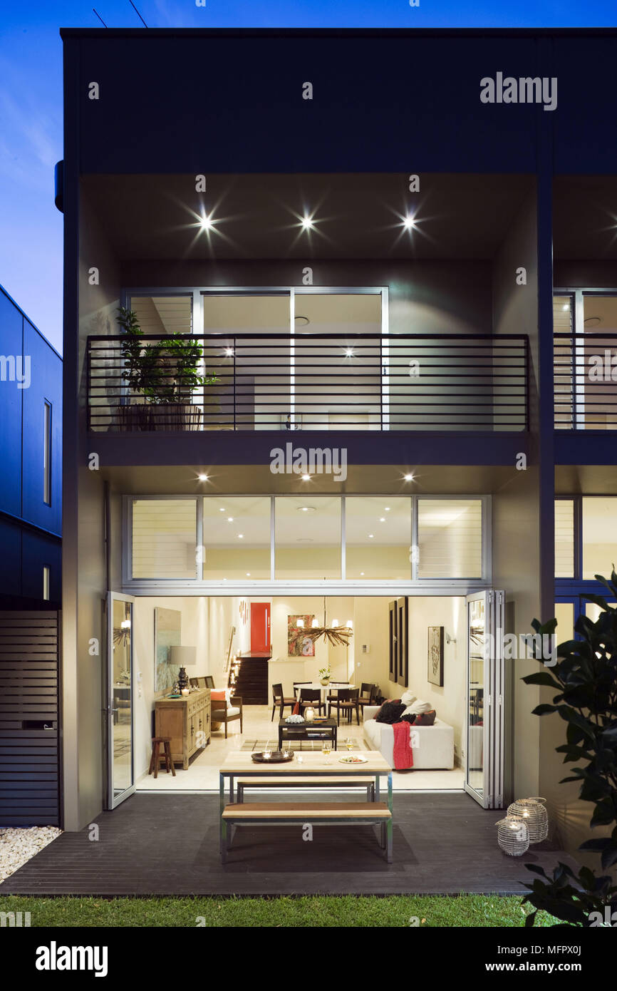 Exterior of modern house with patio at night Stock Photo - Alamy