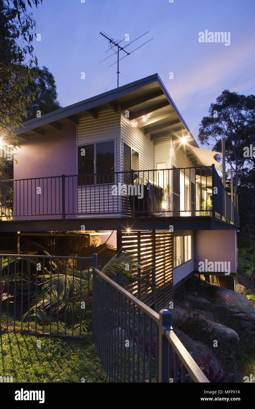 Exterior of modern house with veranda at night Stock Photo - Alamy